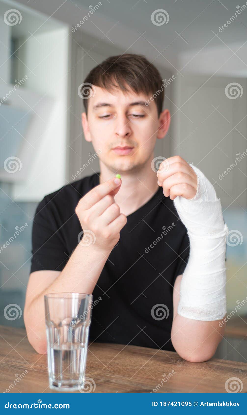 A Man With A Broken Hand Drinks Painkillers. Temporary Health Problems ...