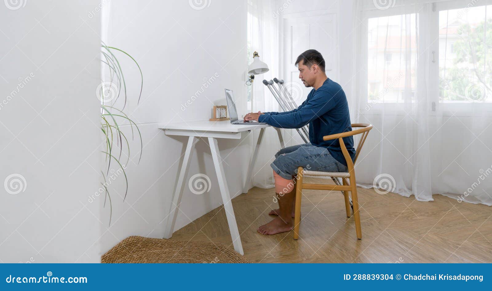 A Man with a Broken Leg Immersed in His Work, Sitting in an Office or ...