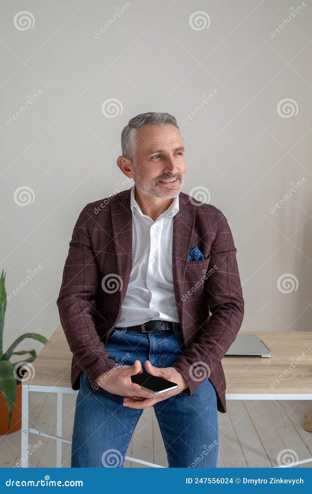 A Man in Brown Jacket Standing Near the Table and Looking Thoughtful ... A Man in Brown Jacket Standing Near the Table and Looking Thoughtful ...