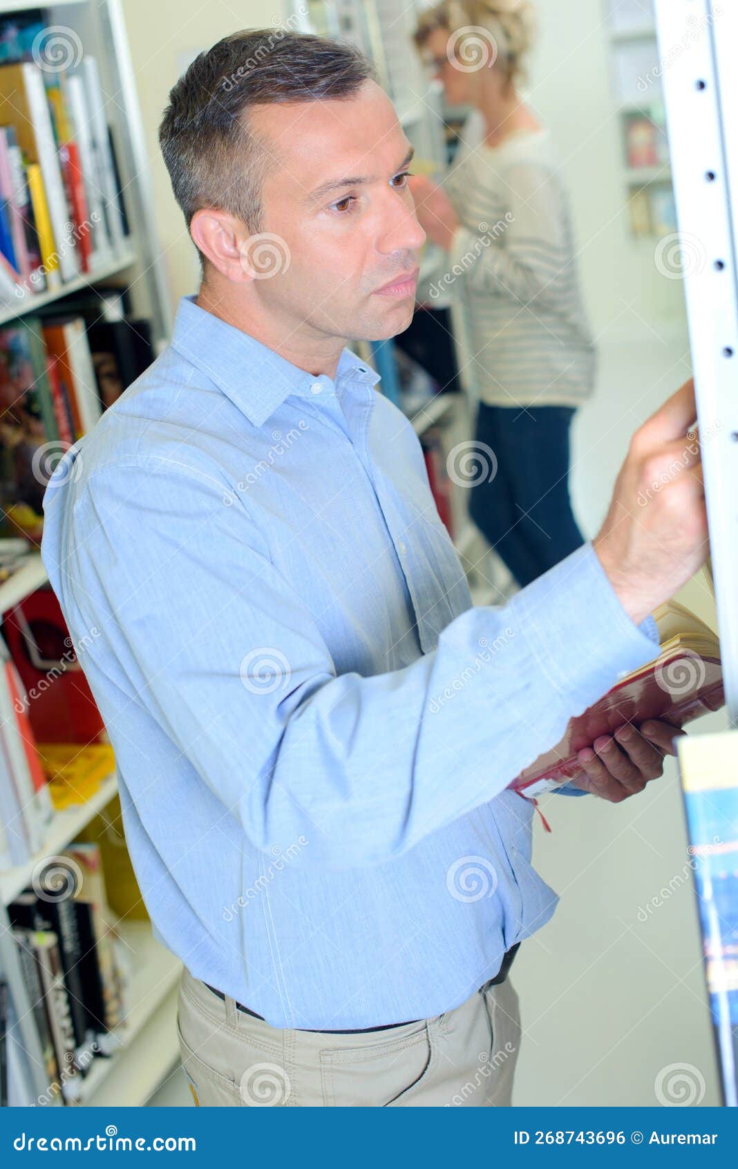 Man Browsing Books on Library Shelf Stock Photo - Image of intelligent ...