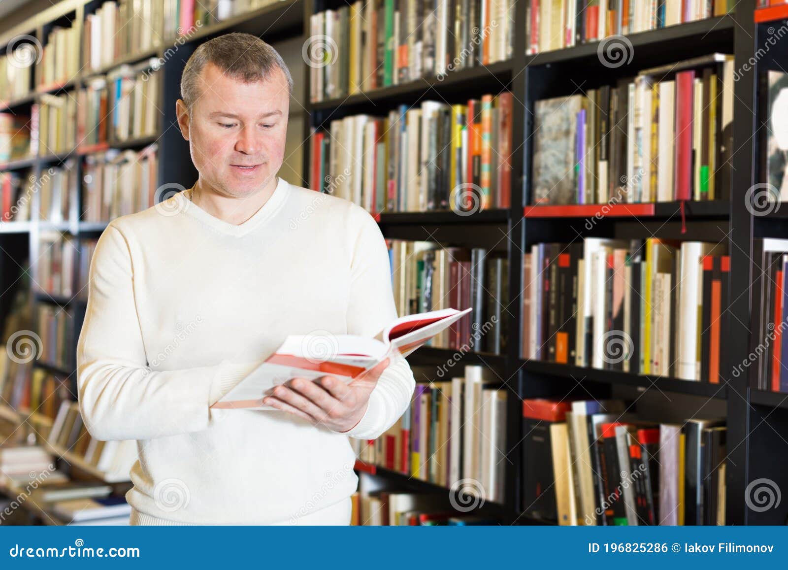 Man Browsing Inside of Books while Visiting Library Stock Photo - Image ...