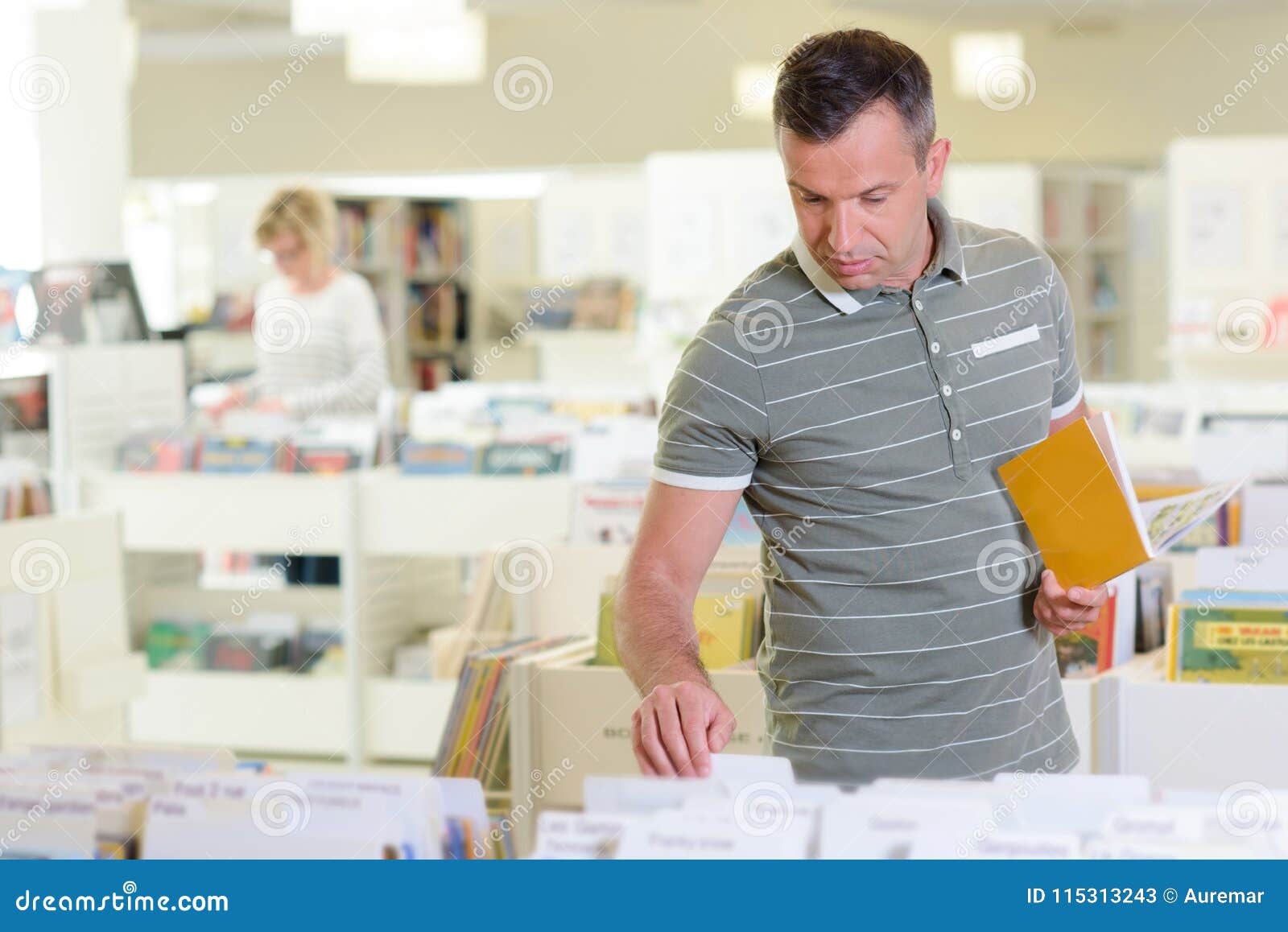 Man browsing in library stock image. Image of borrow - 115313243
