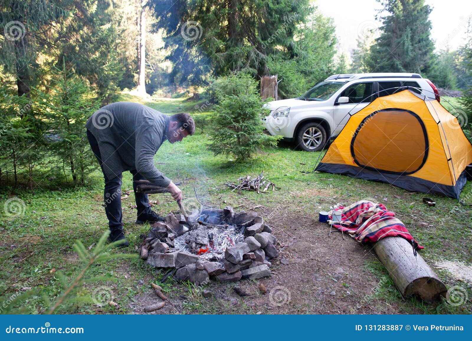 Man Build Fire in Forest, Car with Yellow Tent on Background Stock ...