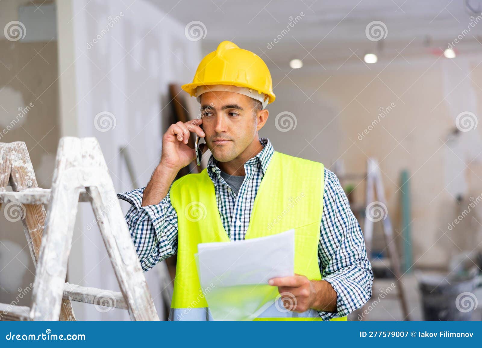 Man Builder Having Telephone Conversation in Construction Site Stock ...