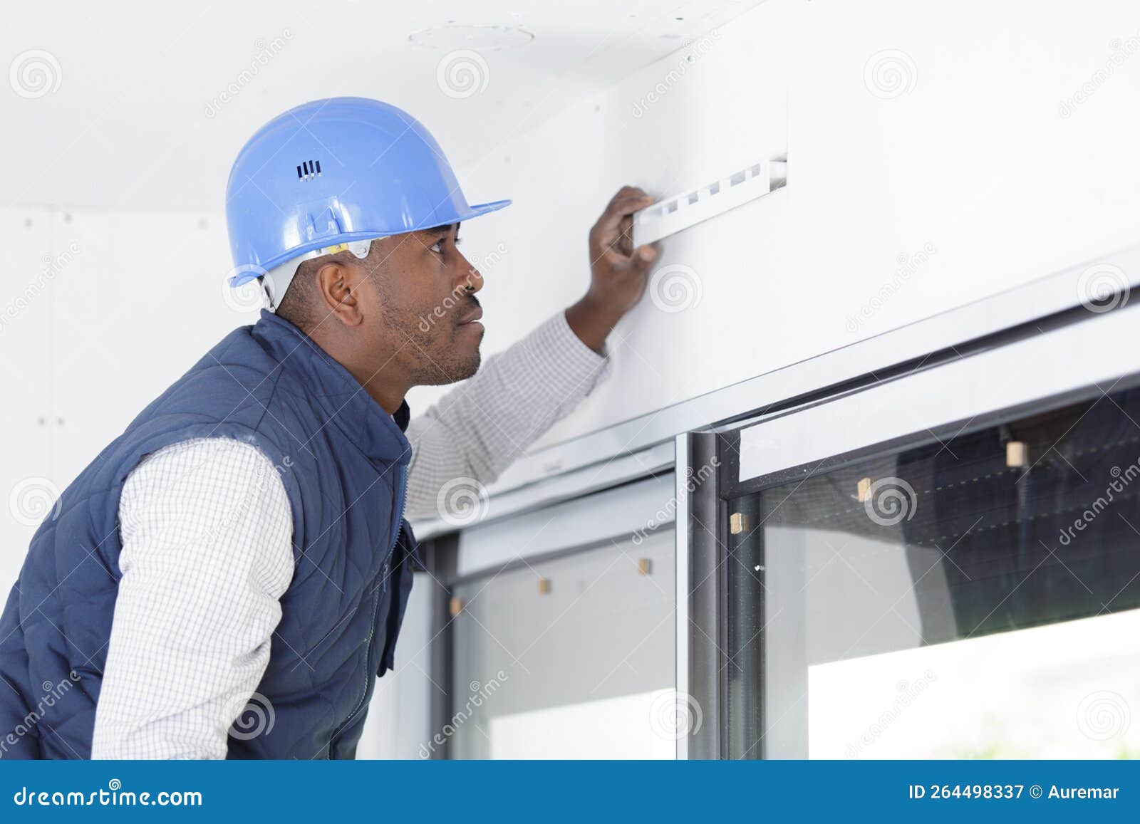 A Man Measures On The Wall With A Ruler, A Tape Measure, A Level, Marks ...
