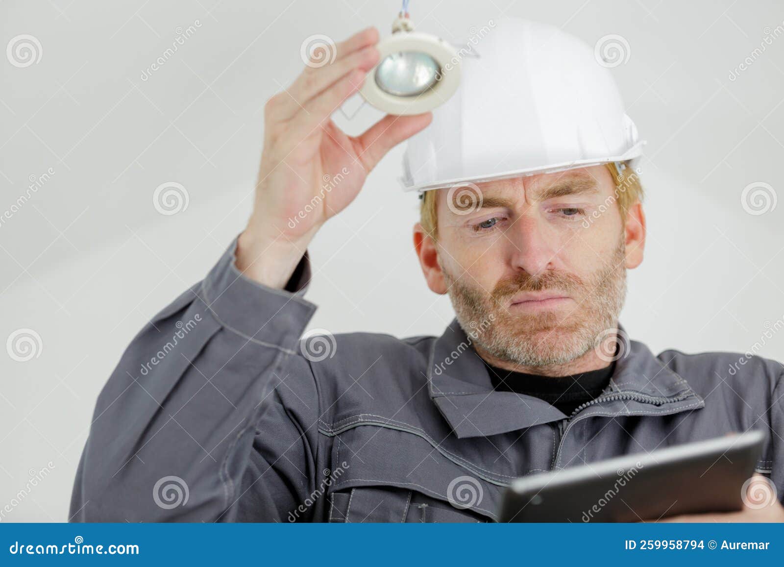 Man in Builder Uniform Installing Light in Ceiling Stock Photo - Image ...