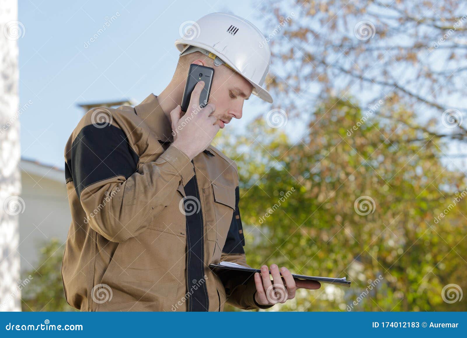 Man builder uses phone stock image. Image of cellphone - 174012183