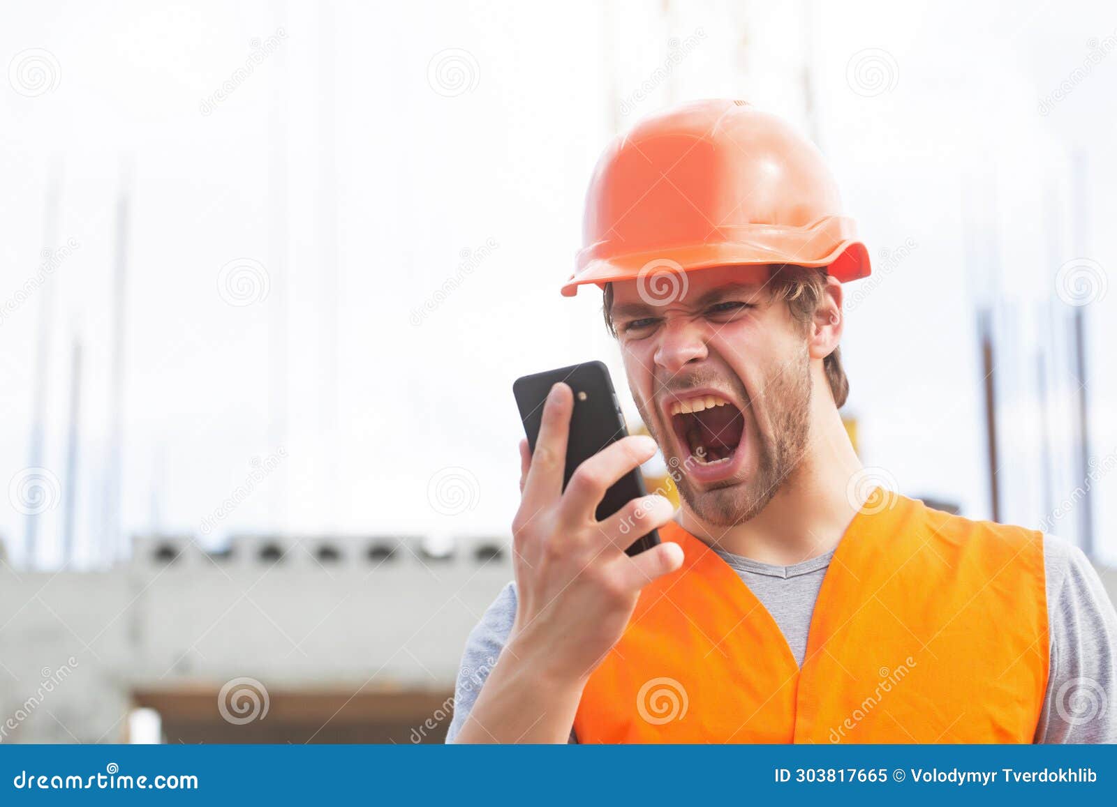 Man Builder Worker in Helmet Screaming in Mobile Phone on Construction ...
