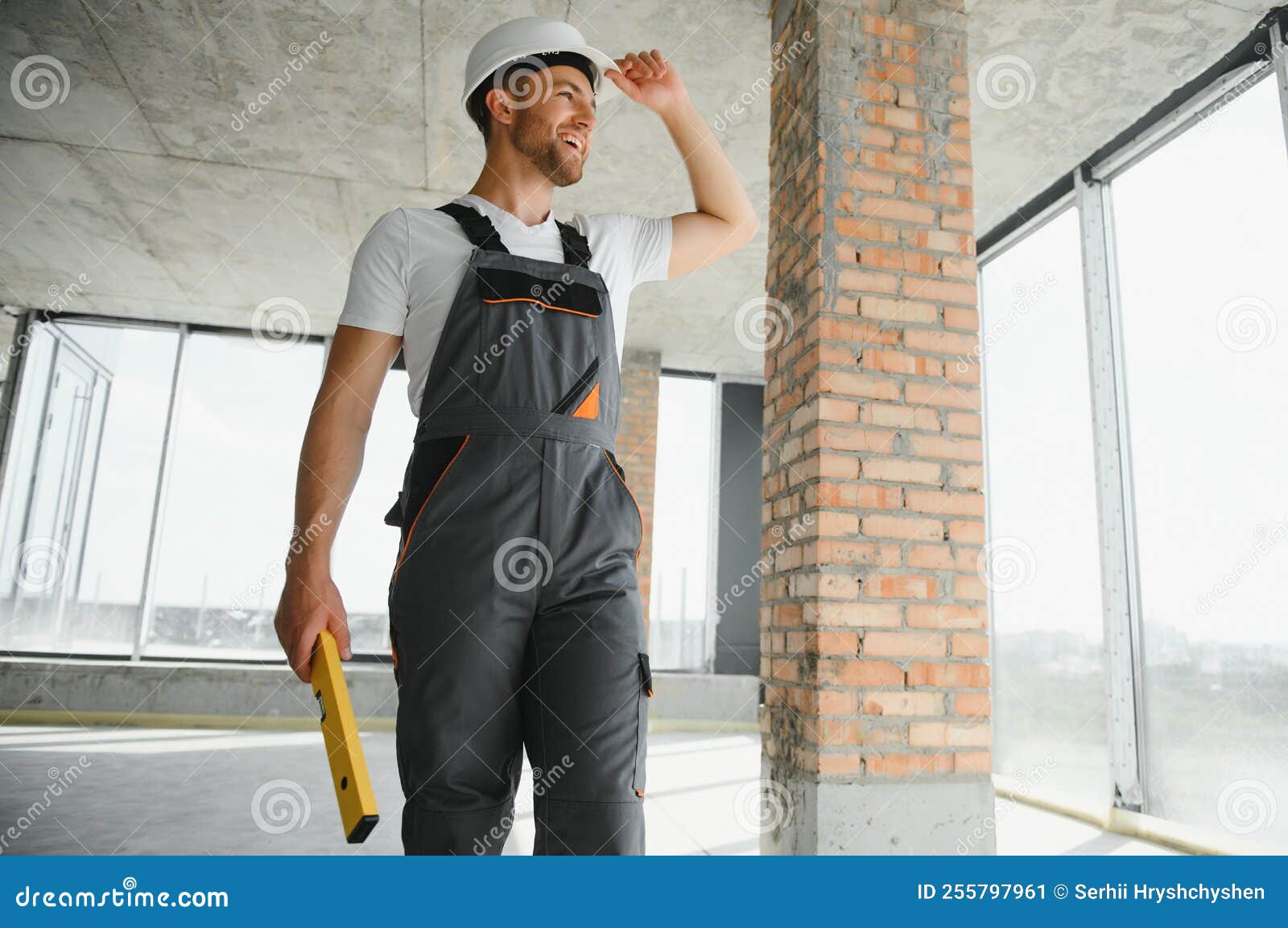 Man Builder Working in Construction Site. Male Repairer in Overall and ...