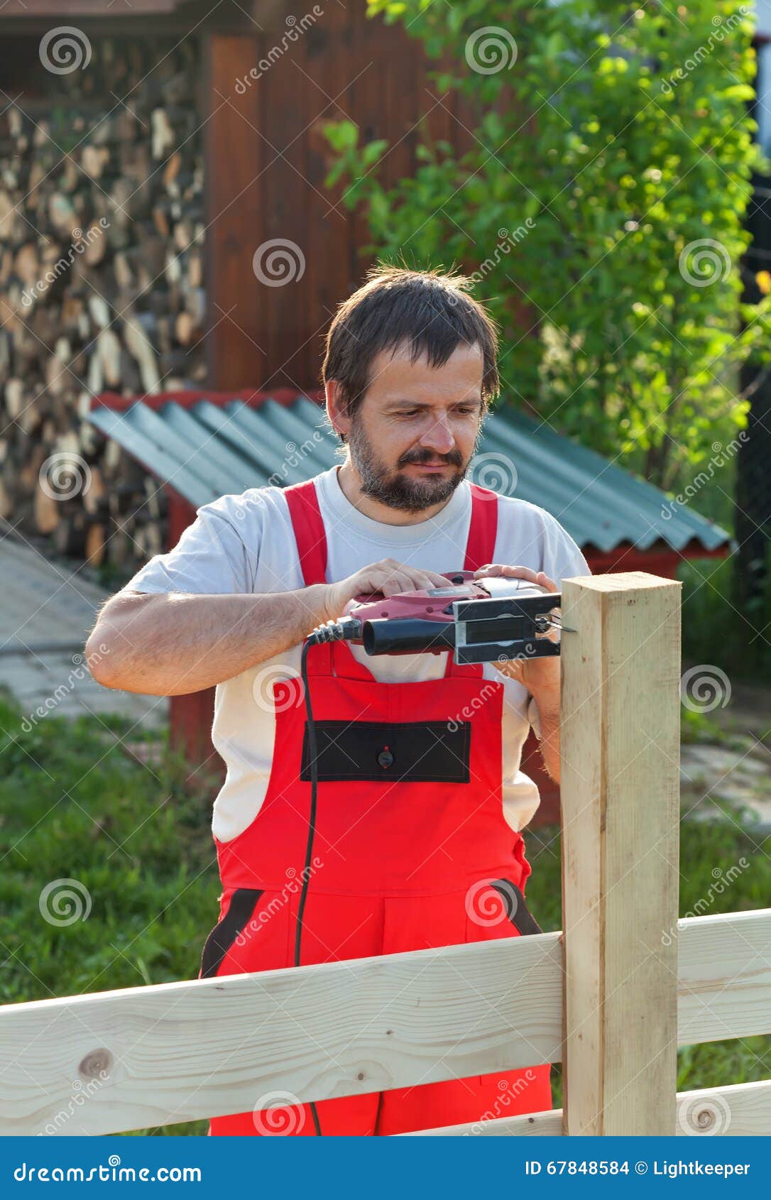 Man building a fence stock photo. Image of manual, fence - 67848584