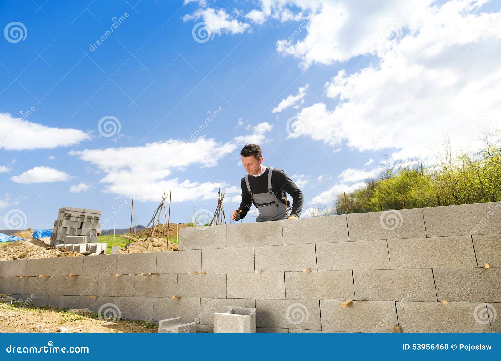 Man building a house stock photo. Image of spring, site - 53956460