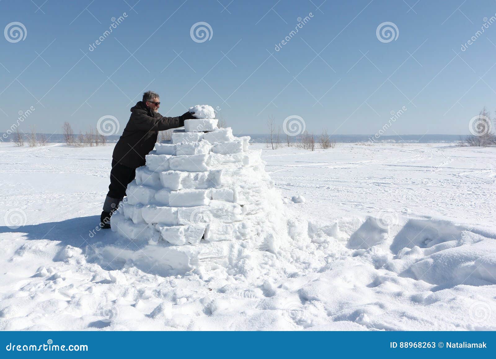 Man Building an Igloo on a Glade Stock Image - Image of blue, horizon ...
