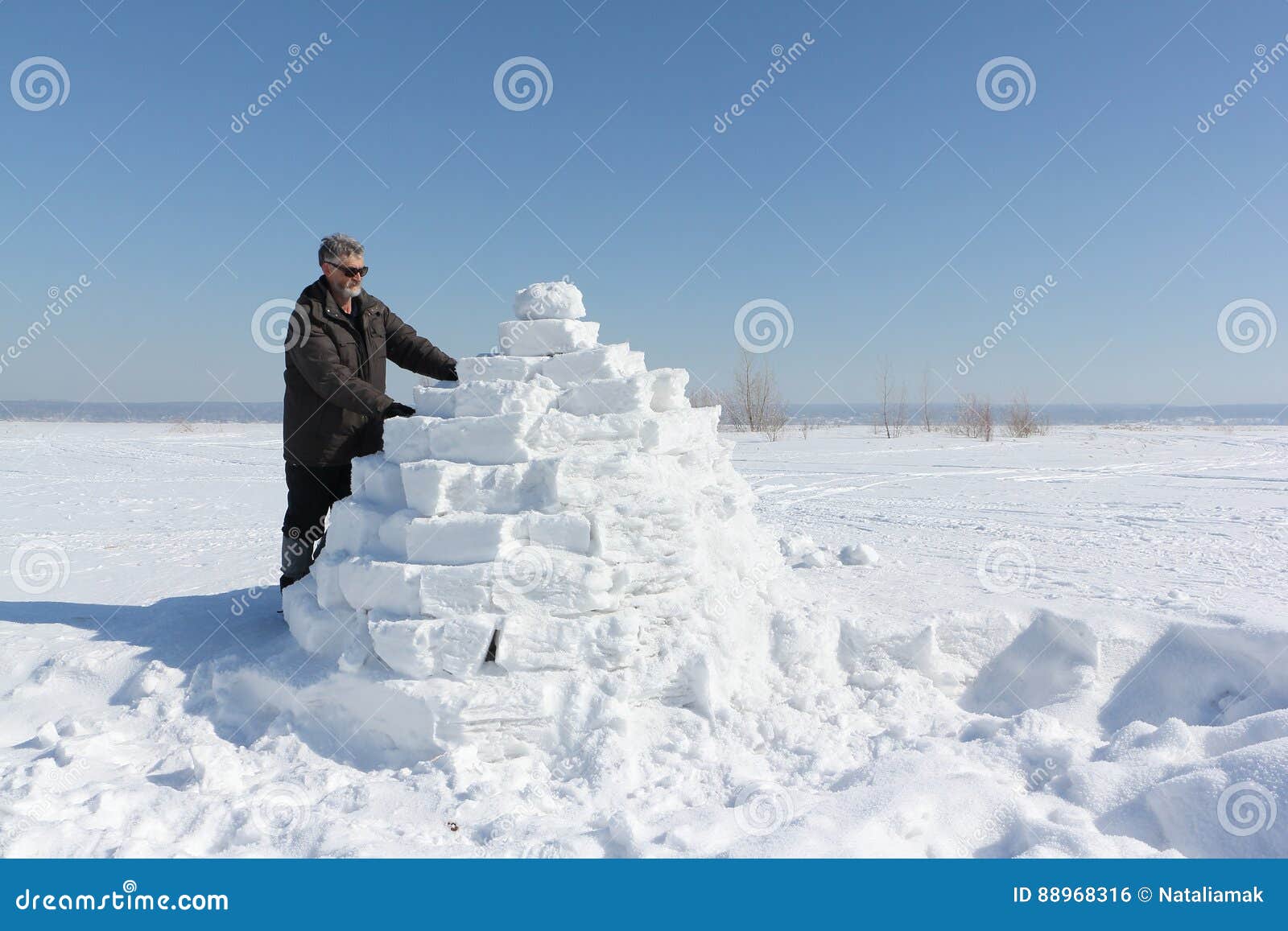 Man Building an Igloo on a Glade Stock Photo - Image of leisure, coast ...