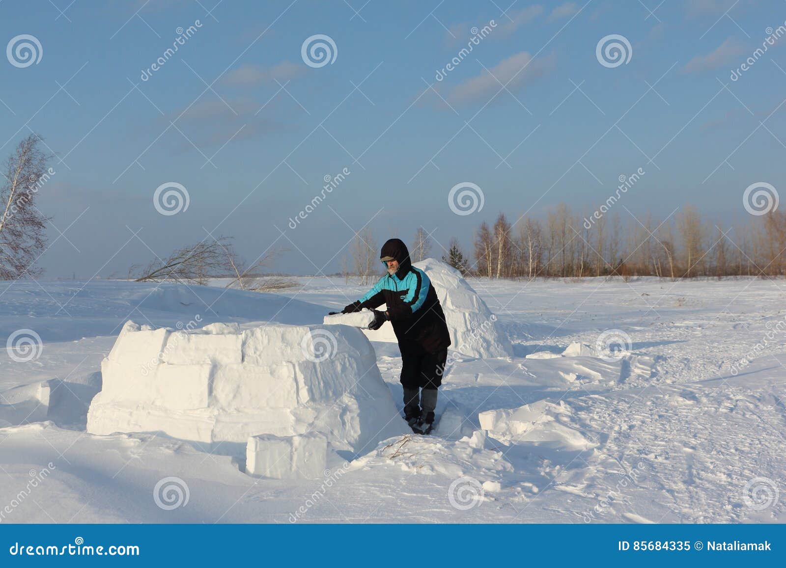 Man Building an Igloo of Snow Blocks in the Winter Stock Image - Image ...