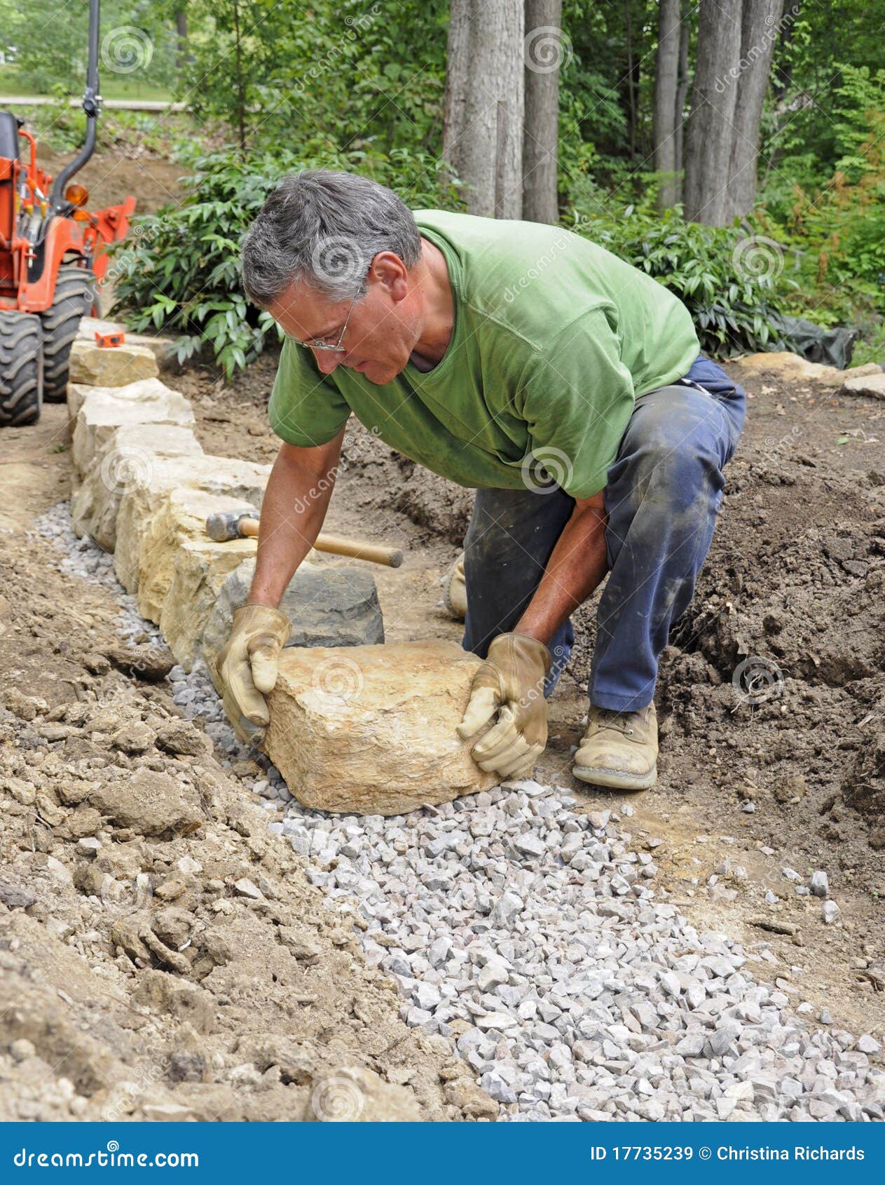 Man building stone wall stock image. Image of garden - 17735239