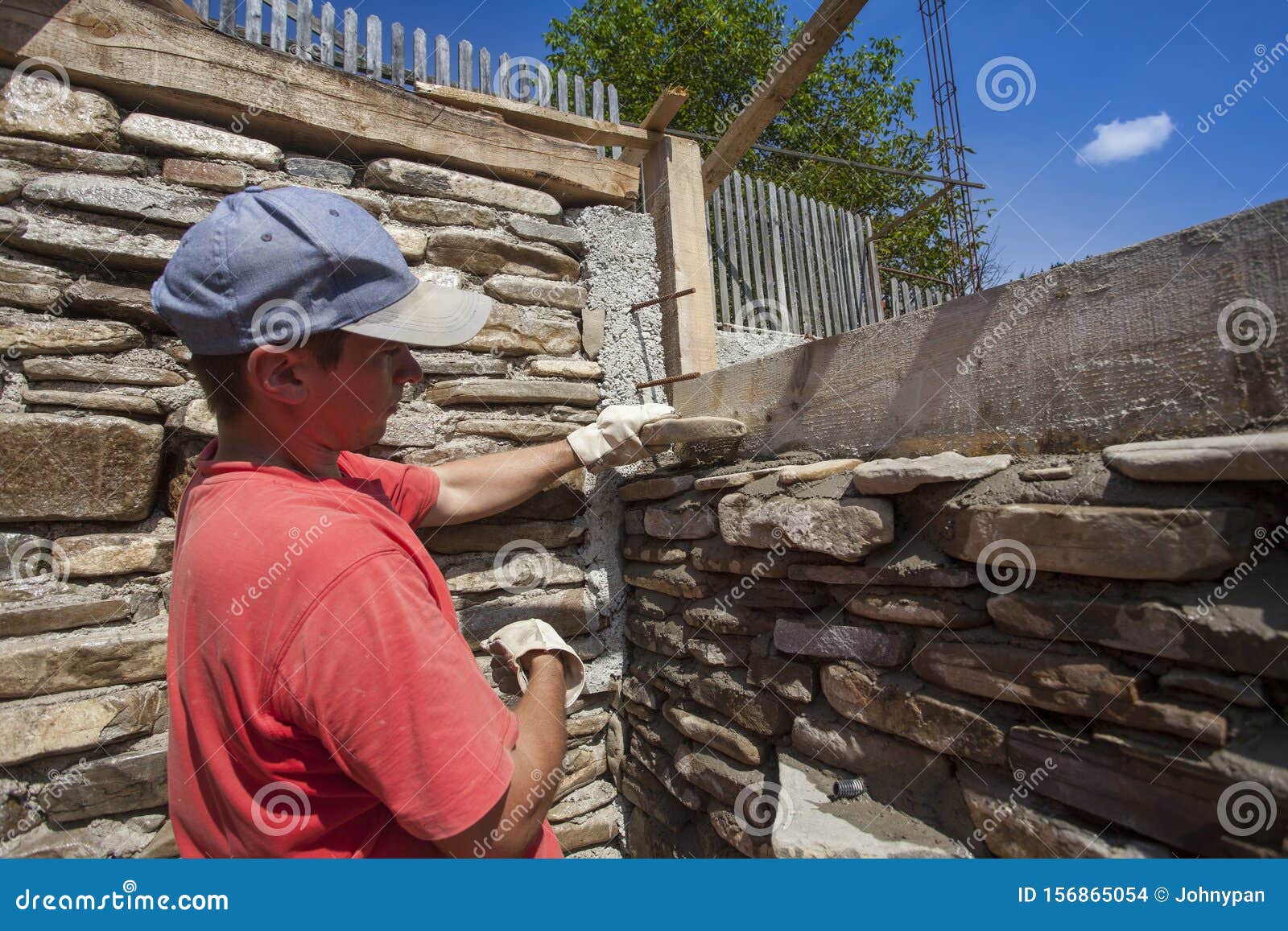 Man building stone wall stock photo. Image of hard, occupation - 156865054