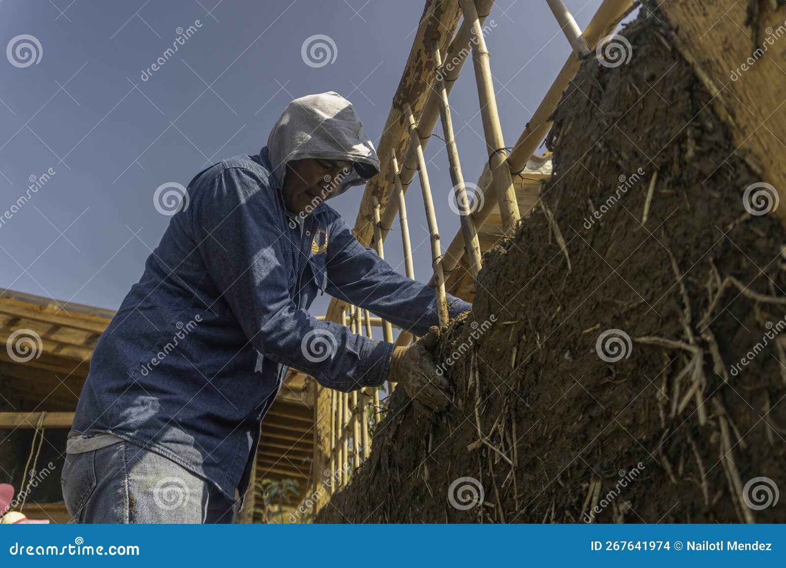 Man Building a Wall with Bioconstruction Techniques Stock Photo - Image ...