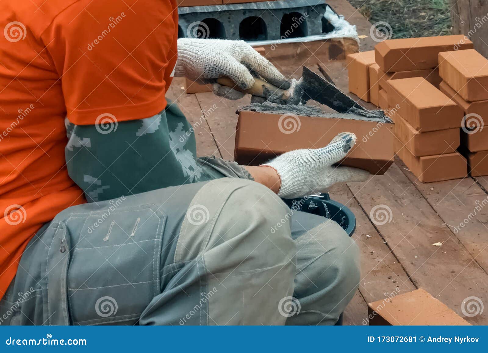 A Man Builds a Brick Wall. Brick Put on the Solution Stock Image ...