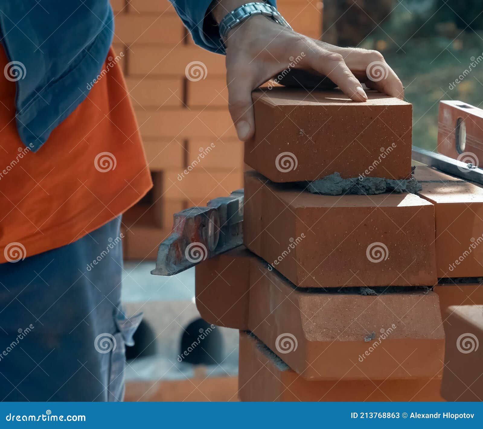 A Man Builds a Brick Wall. Brick Put on the Solution Stock Image ...