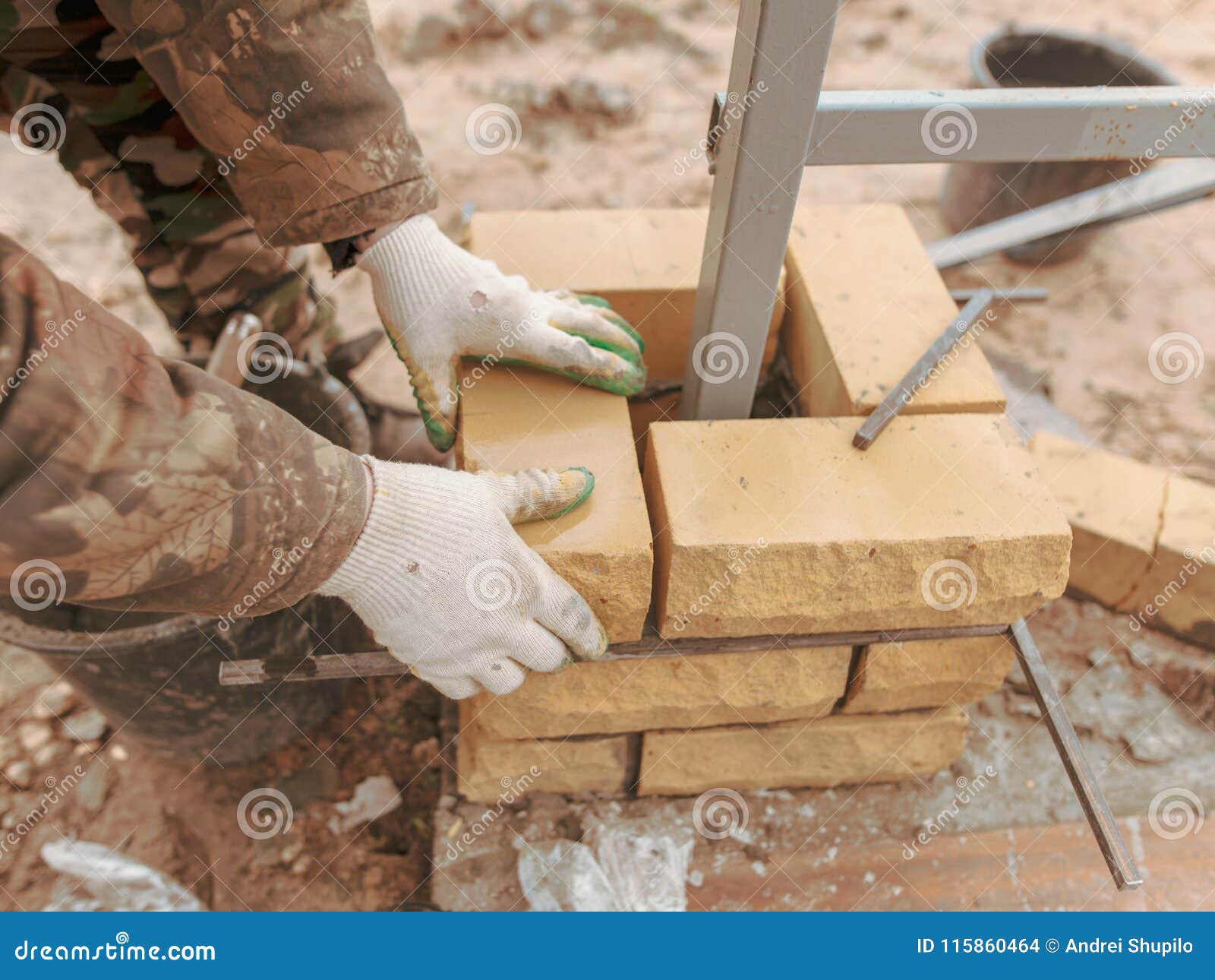 Man Builds a Brick Wall at a Construction Site Stock Photo - Image of ...
