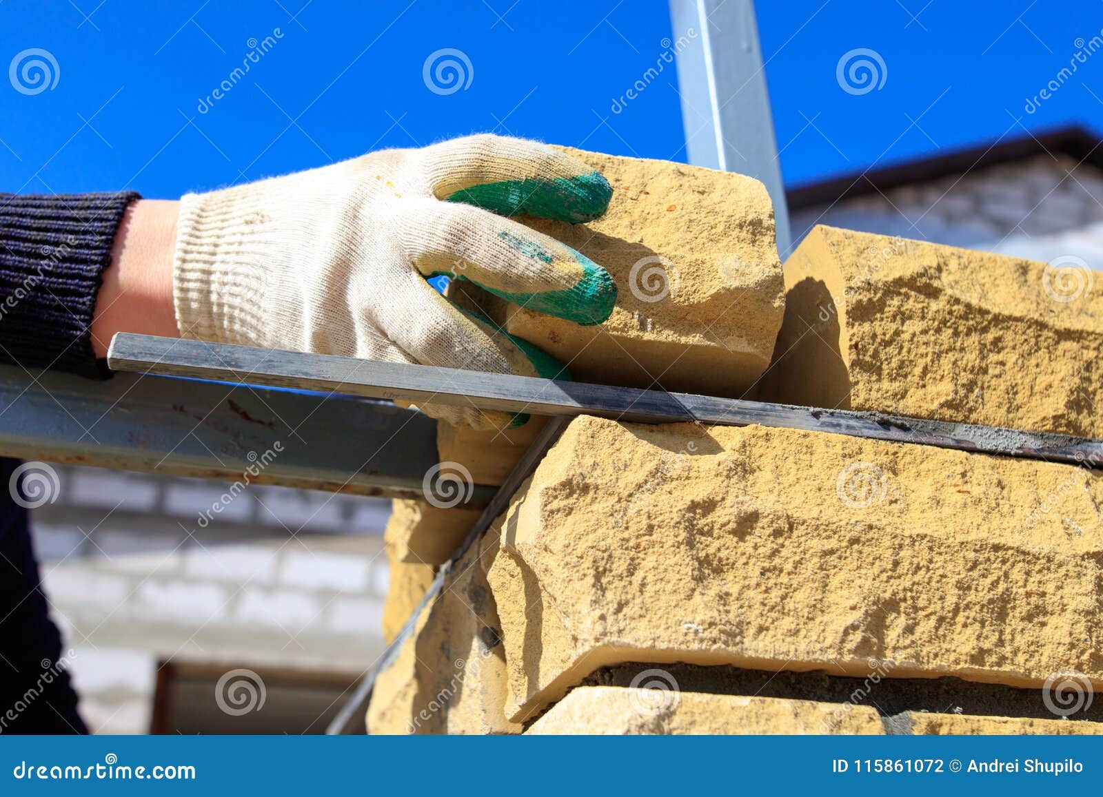 Man Builds a Brick Wall at a Construction Site Stock Photo - Image of ...