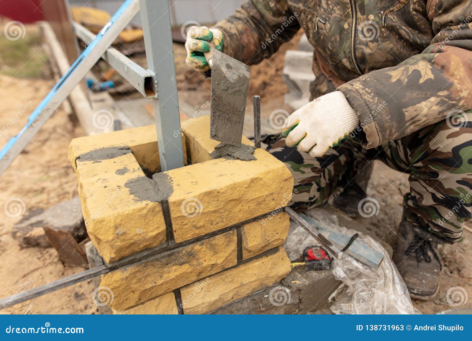 Man Builds a Brick Wall at a Construction Site Stock Image - Image of ...