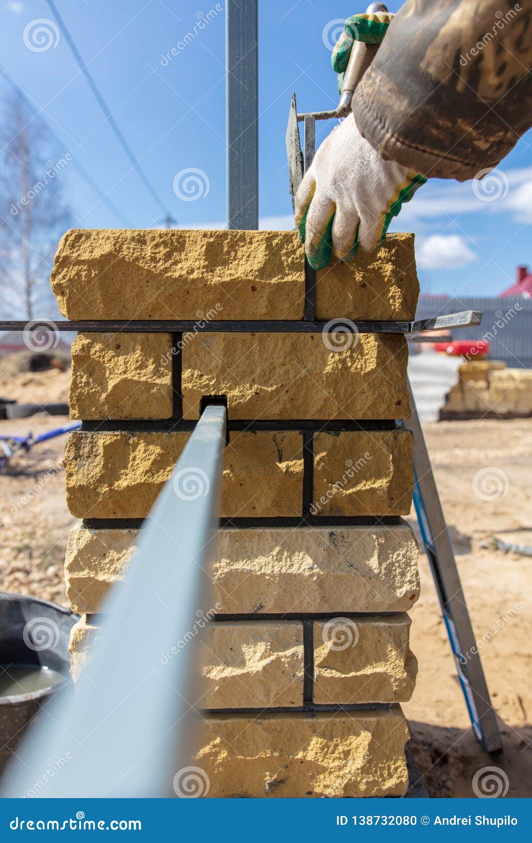 Man Builds a Brick Wall at a Construction Site Stock Photo - Image of ...