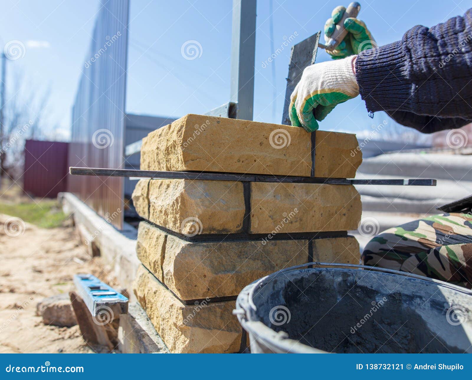 Man Builds a Brick Wall at a Construction Site Stock Image - Image of ...