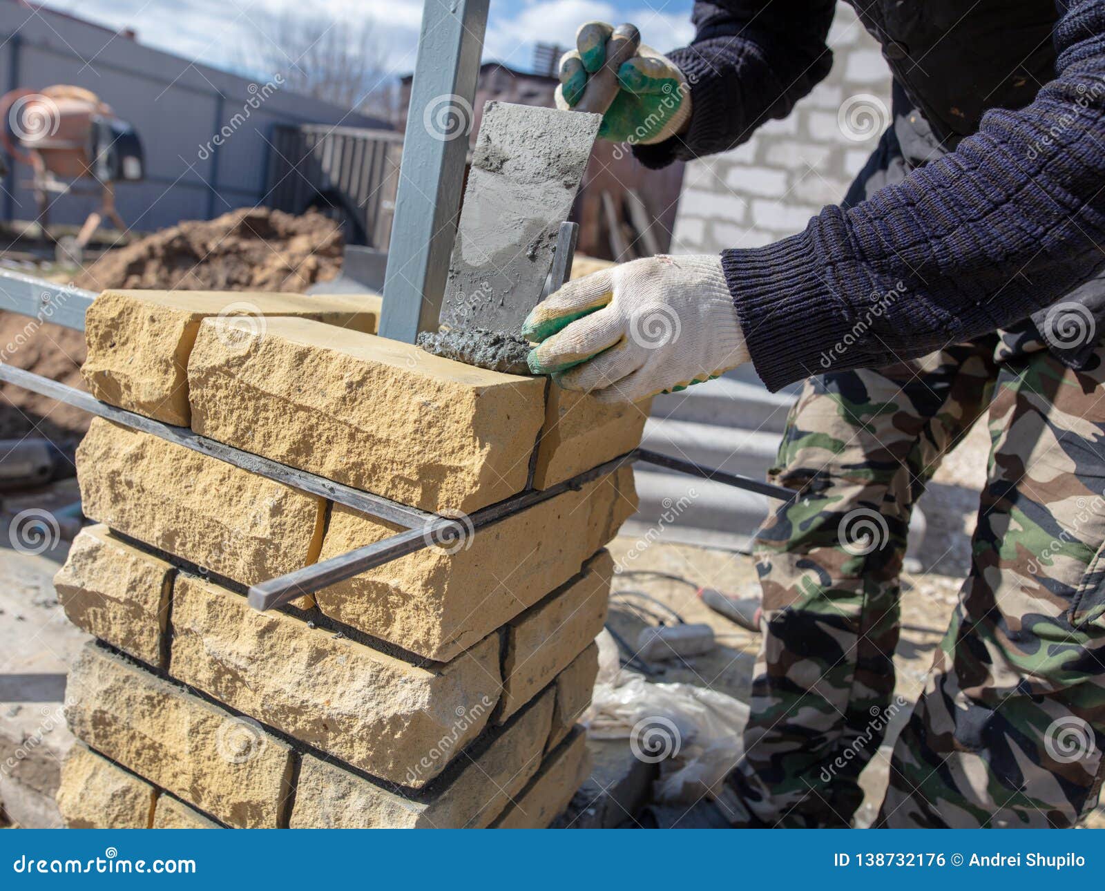 Man Builds a Brick Wall at a Construction Site Stock Photo - Image of ...