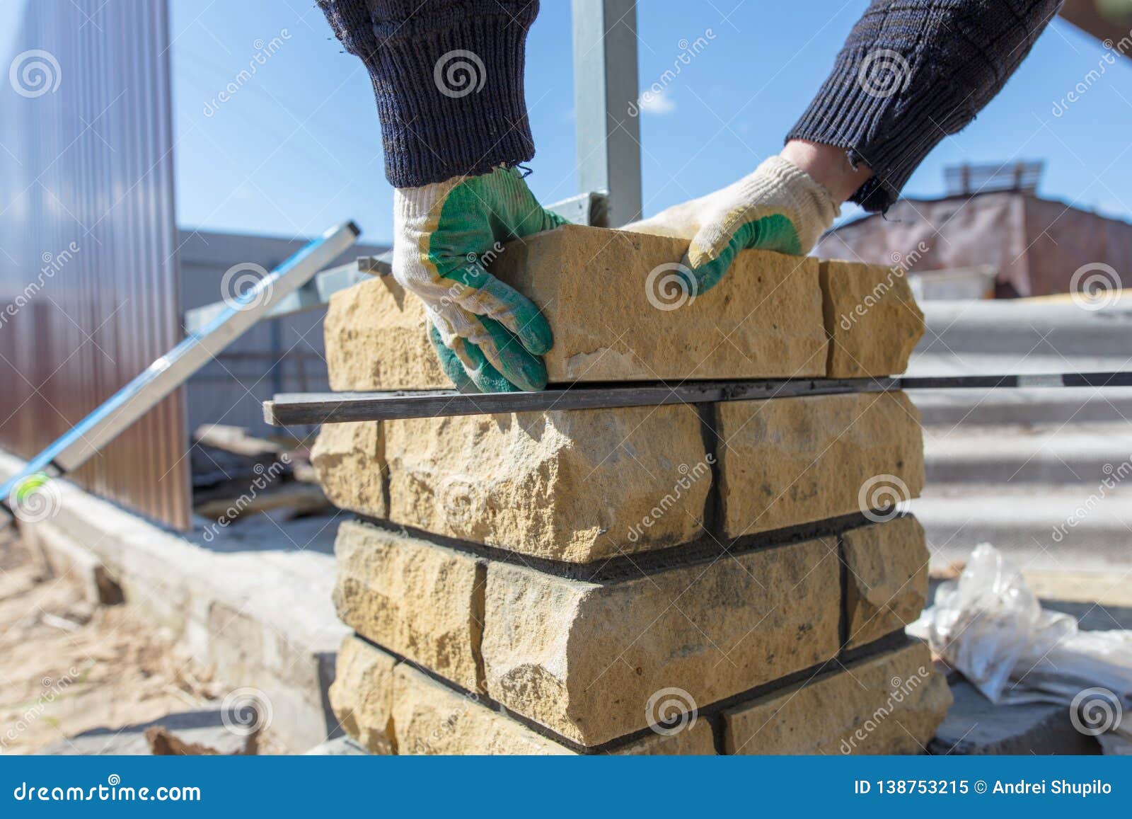 Man Builds a Brick Wall at a Construction Site Stock Image - Image of ...