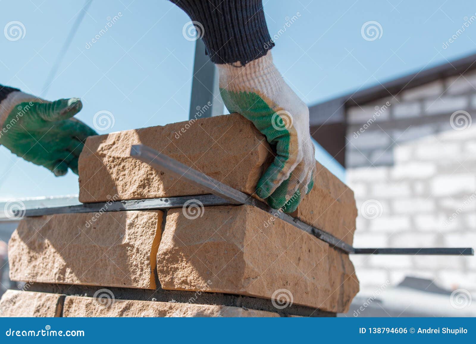 Man Builds a Brick Wall at a Construction Site Stock Photo - Image of ...