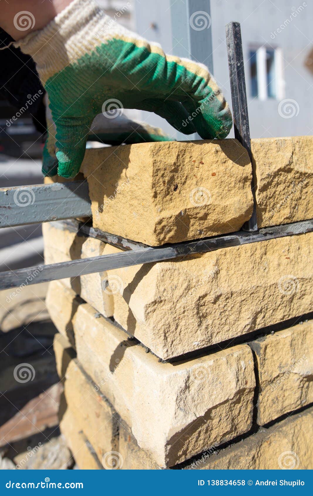 Man Builds a Brick Wall at a Construction Site Stock Photo - Image of ...