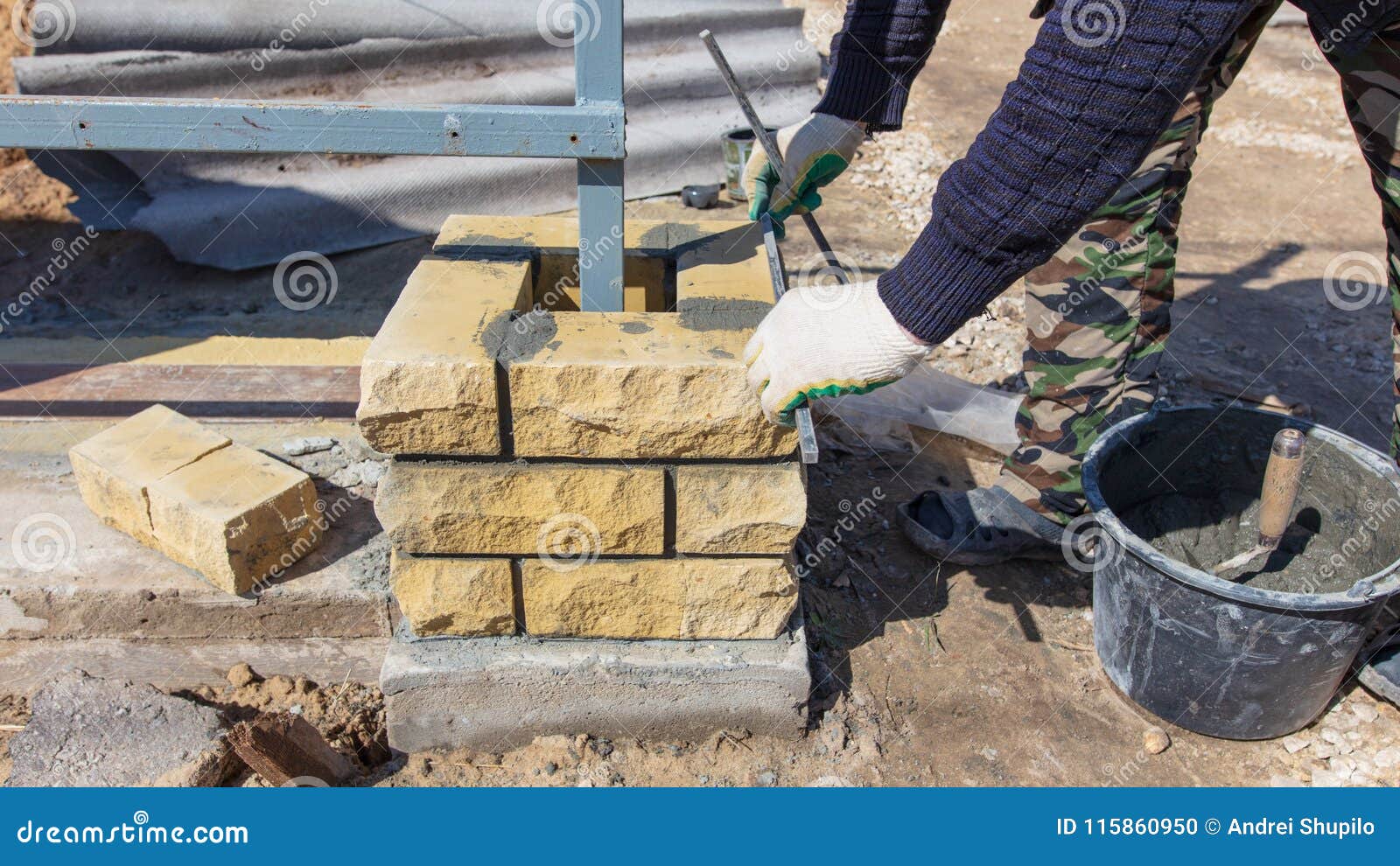Man Builds a Brick Wall at a Construction Site Stock Photo - Image of ...