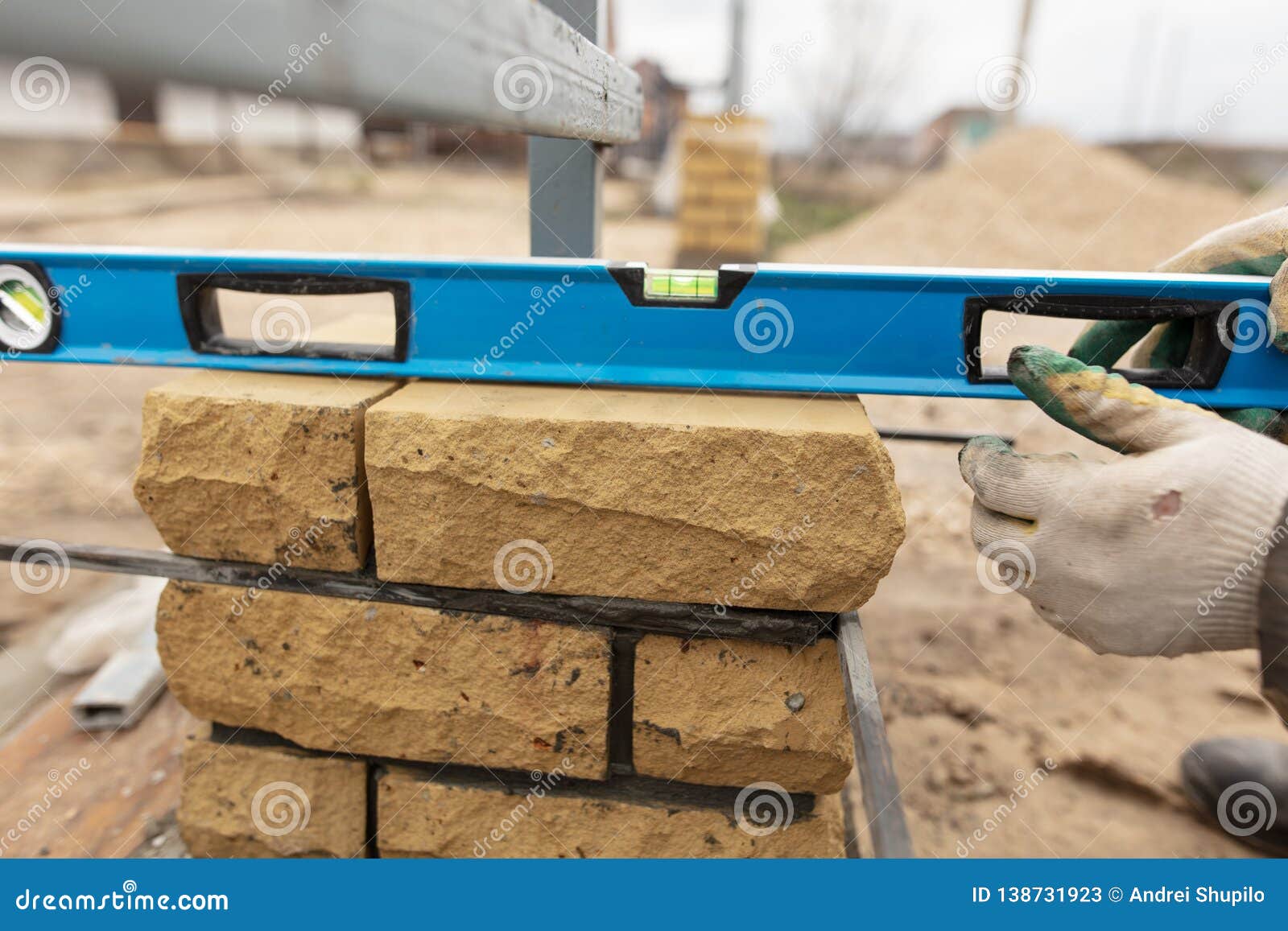 Man Builds a Brick Wall at a Construction Site Stock Image - Image of ...