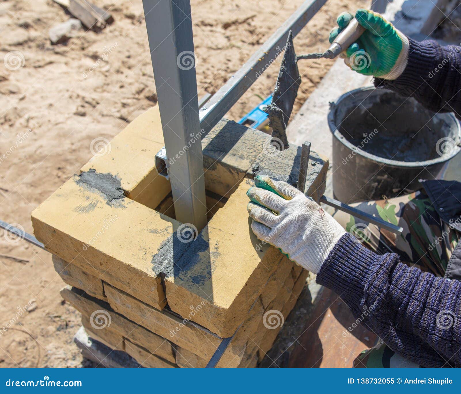 Man Builds a Brick Wall at a Construction Site Stock Image - Image of ...