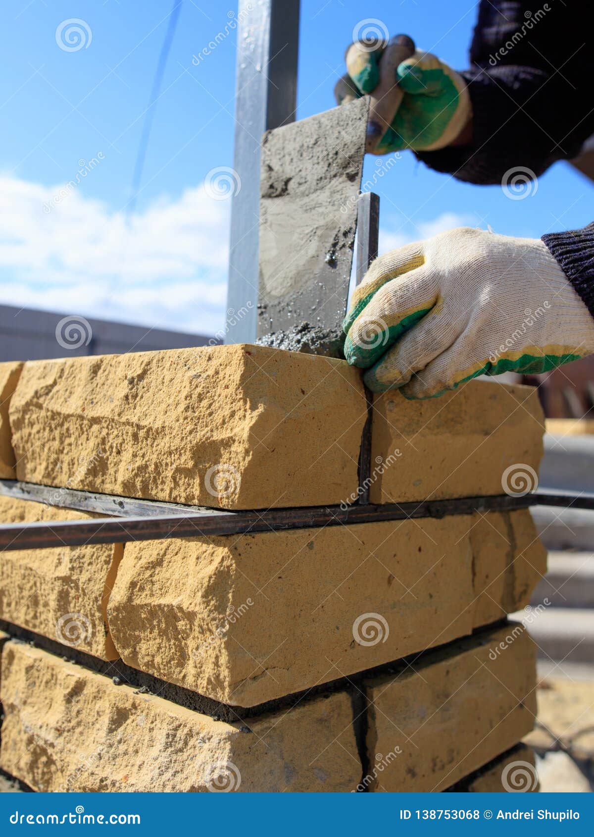 Man Builds a Brick Wall at a Construction Site Stock Photo - Image of ...