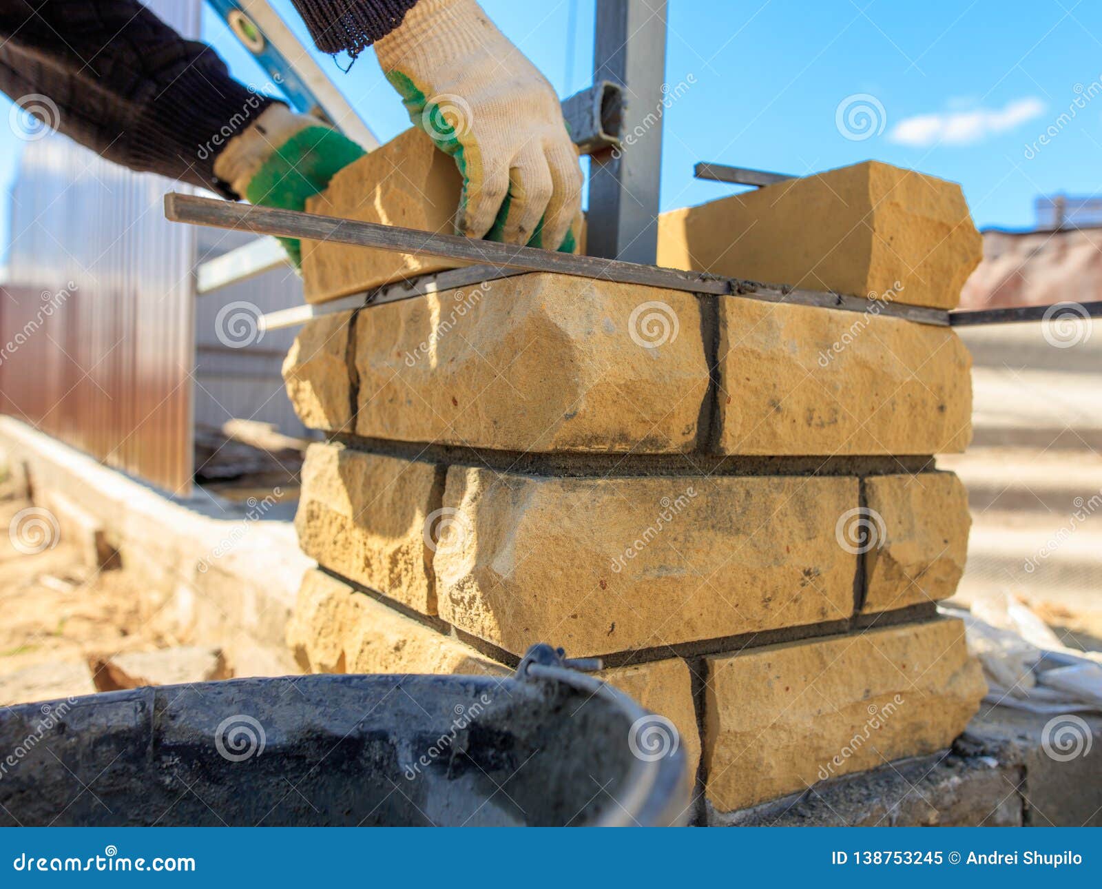 Man Builds a Brick Wall at a Construction Site Stock Image - Image of ...