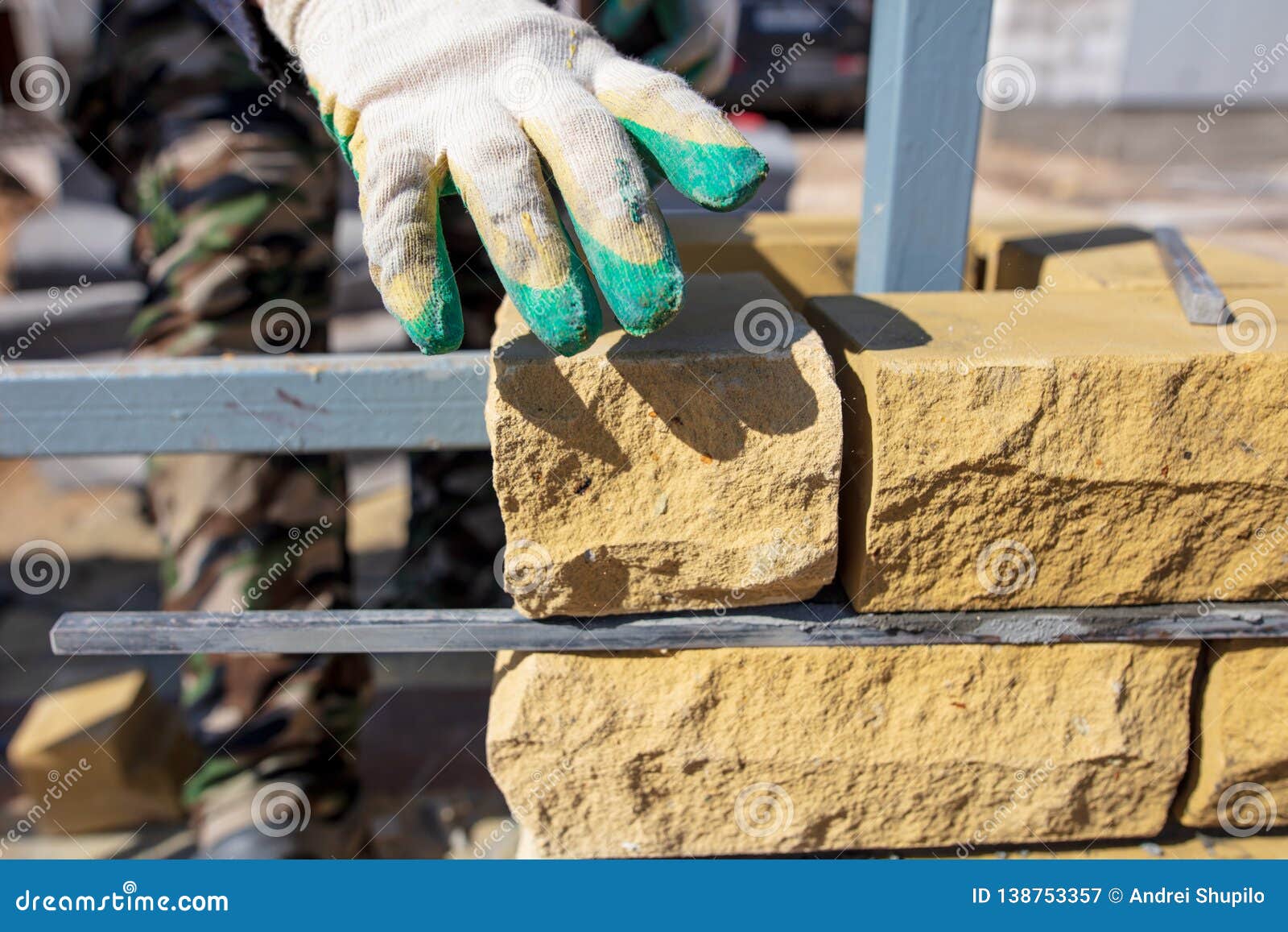Man Builds a Brick Wall at a Construction Site Stock Image - Image of ...