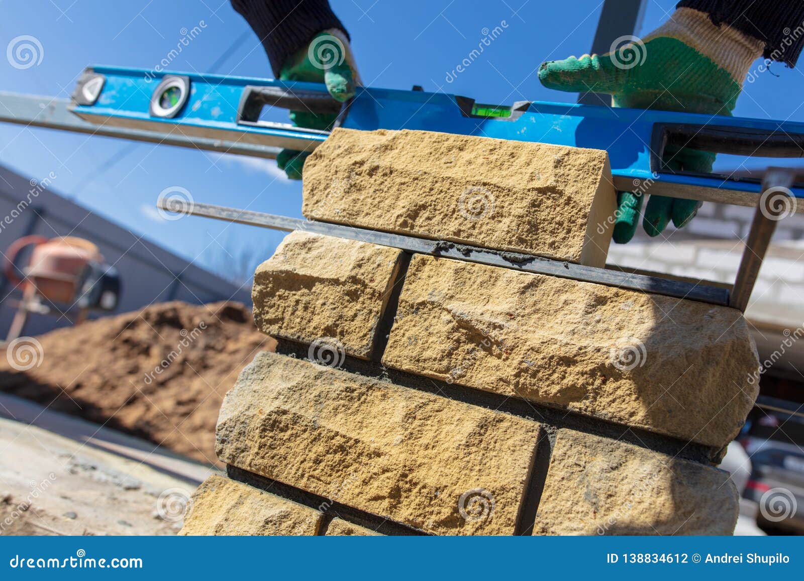 Man Builds a Brick Wall at a Construction Site Stock Photo - Image of ...