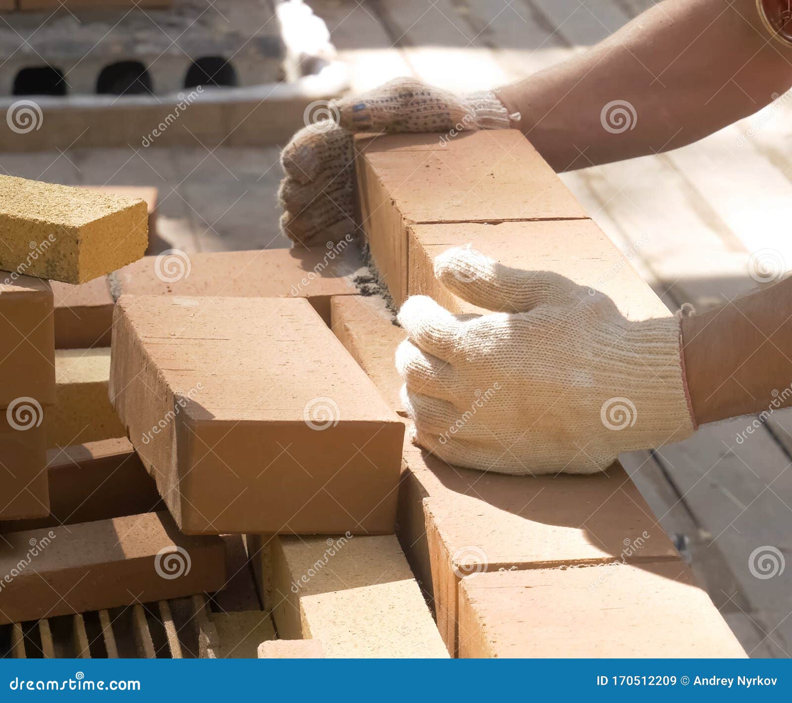 A Man Builds a Brick Wall. Brick Put on the Solution Stock Image ...