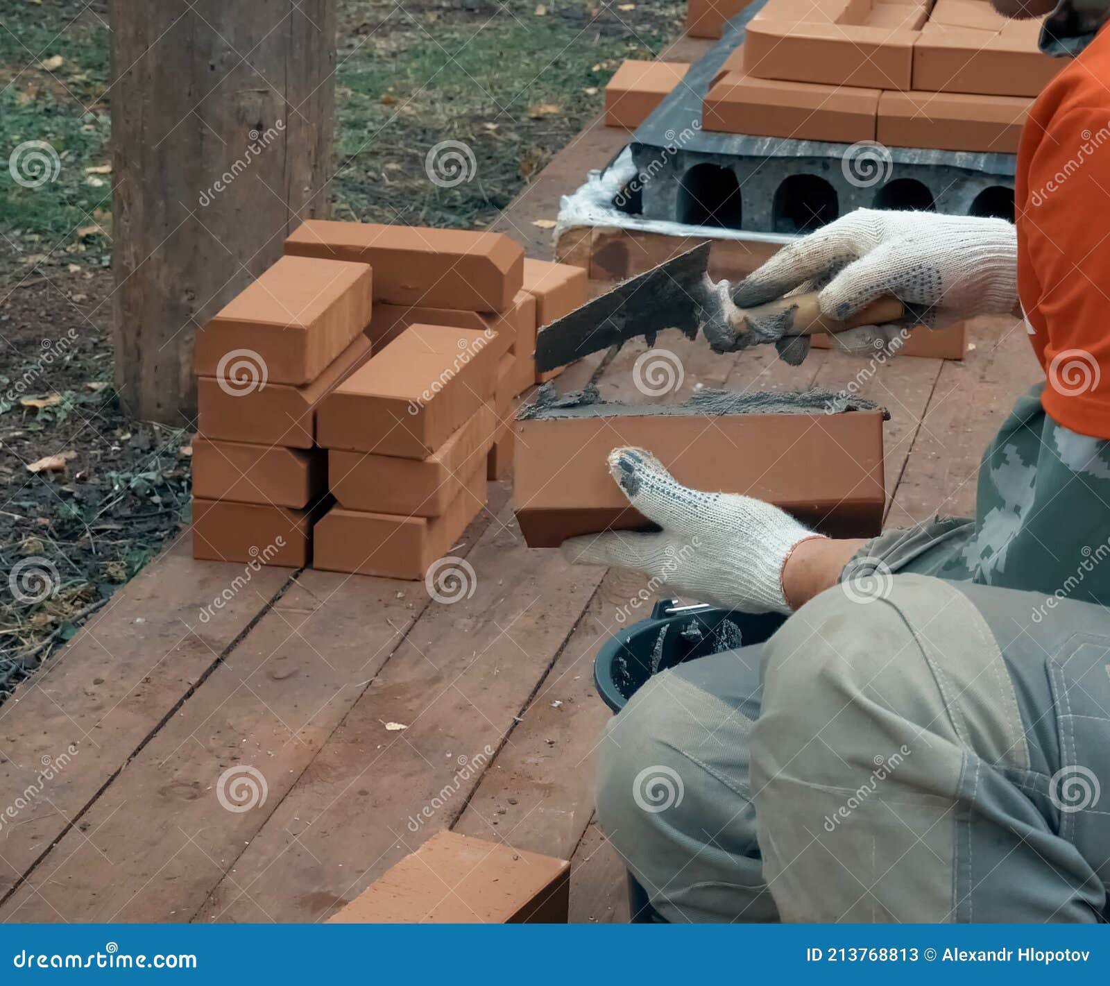 A Man Builds a Brick Wall. Brick Put on the Solution Stock Image ...