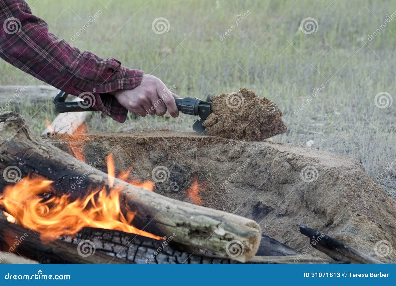 Man Builds Fire Pit Around Open Camp Fire Stock Image - Image of sand ...