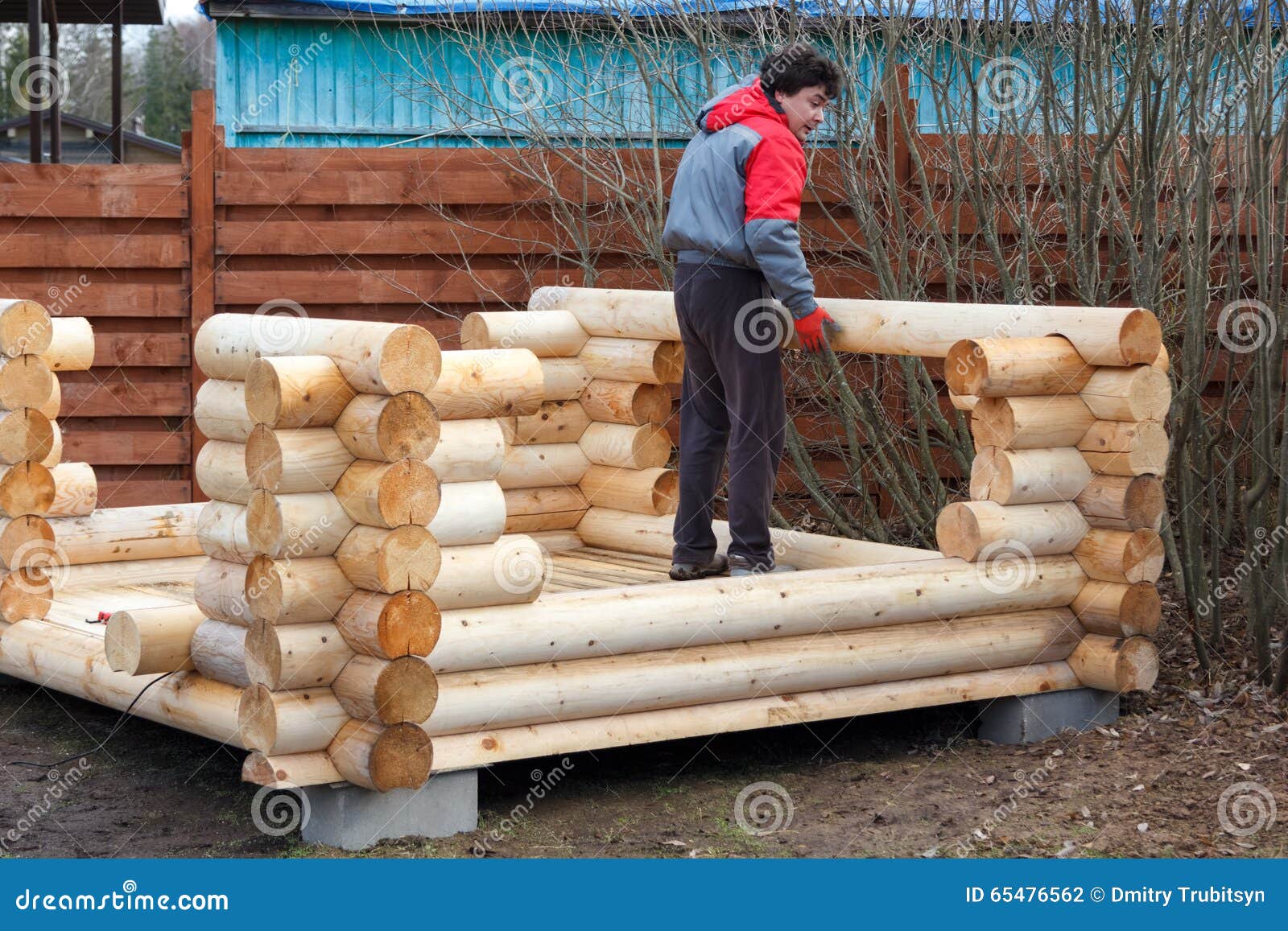 Man Builds Structure Made of Logs Stock Photo - Image of construction ...