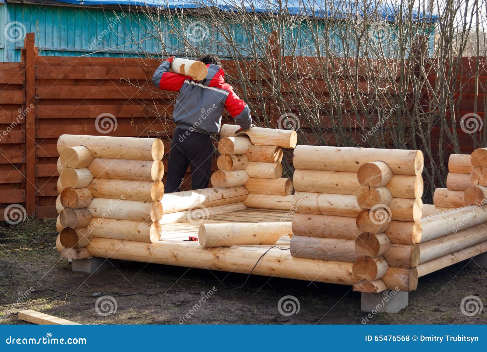 Man Builds Structure Made of Logs Stock Photo - Image of outdoor ...