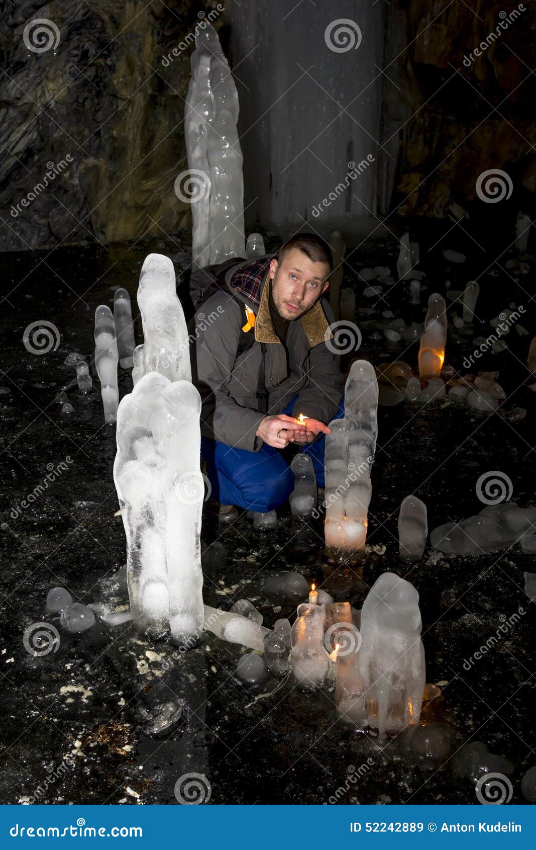 Man with a Burning Candle Sits in a Cave with Ice Blocks Stock Image ...