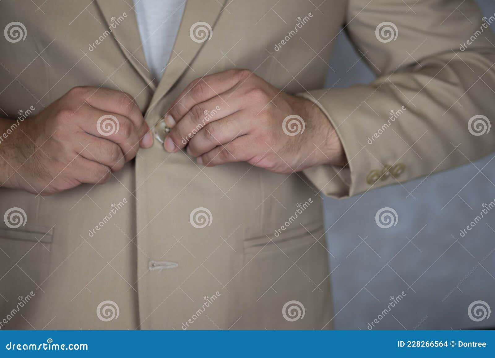 Man is Buttoning the Buttons on the Cream Suit. Close-up Stock Photo ...