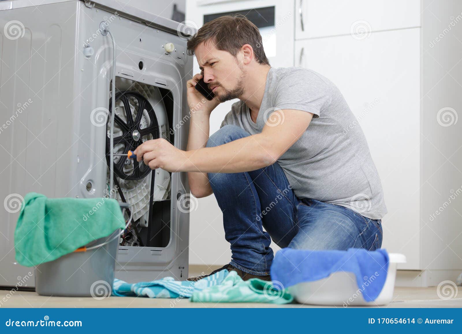 Man Calling Plumber because Washing Machine Problems Stock Photo ...