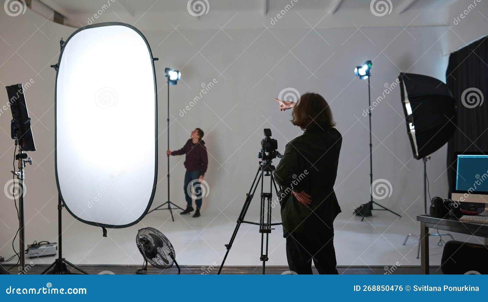 Man with Camera Point on Spotlight for Illuminator Stock Photo - Image ...
