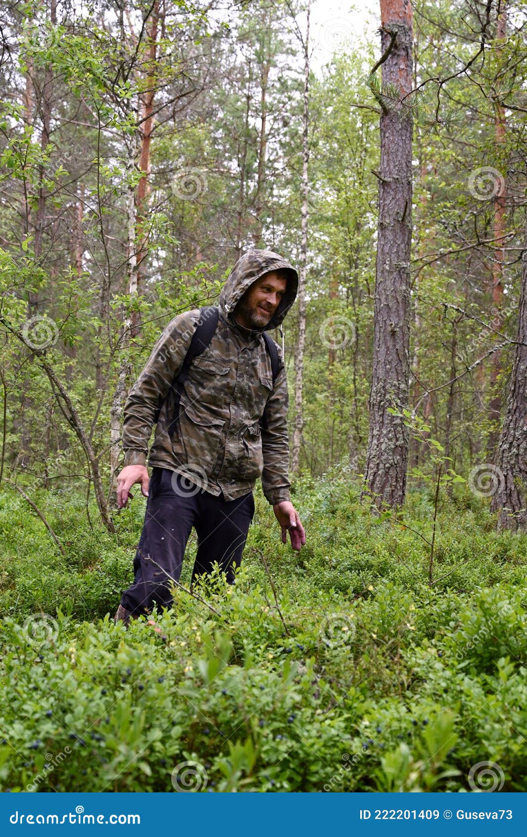 Man in Camouflage Clothing with a Backpack in the Woods. Stock Image ...