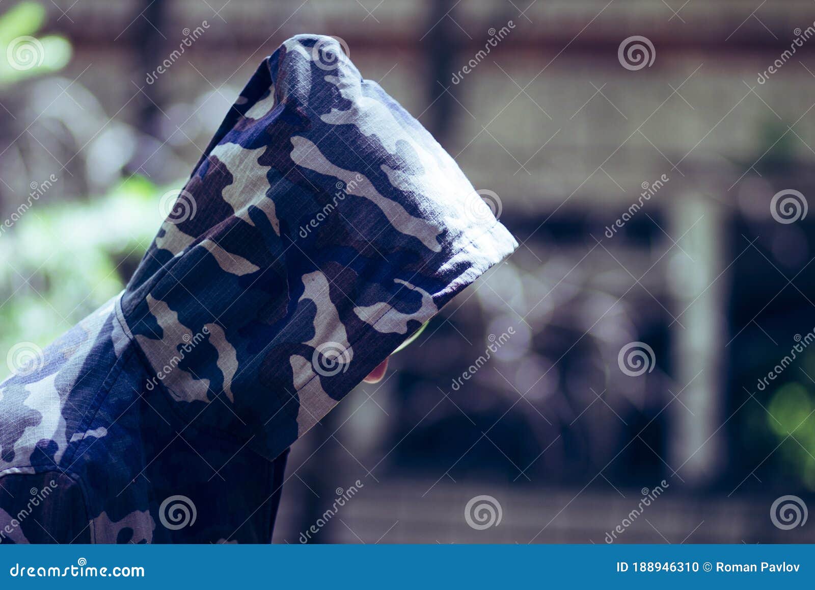 A Man in Camouflage with a Hood Pulled Down Stock Photo - Image of ...